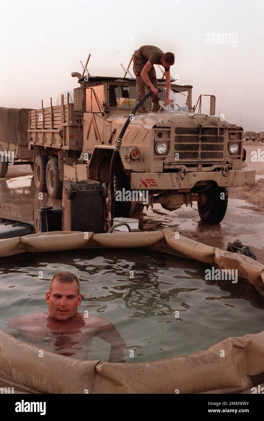 A Marine of Headquarters Battalion, 2nd Marine Division, cools off in a ...