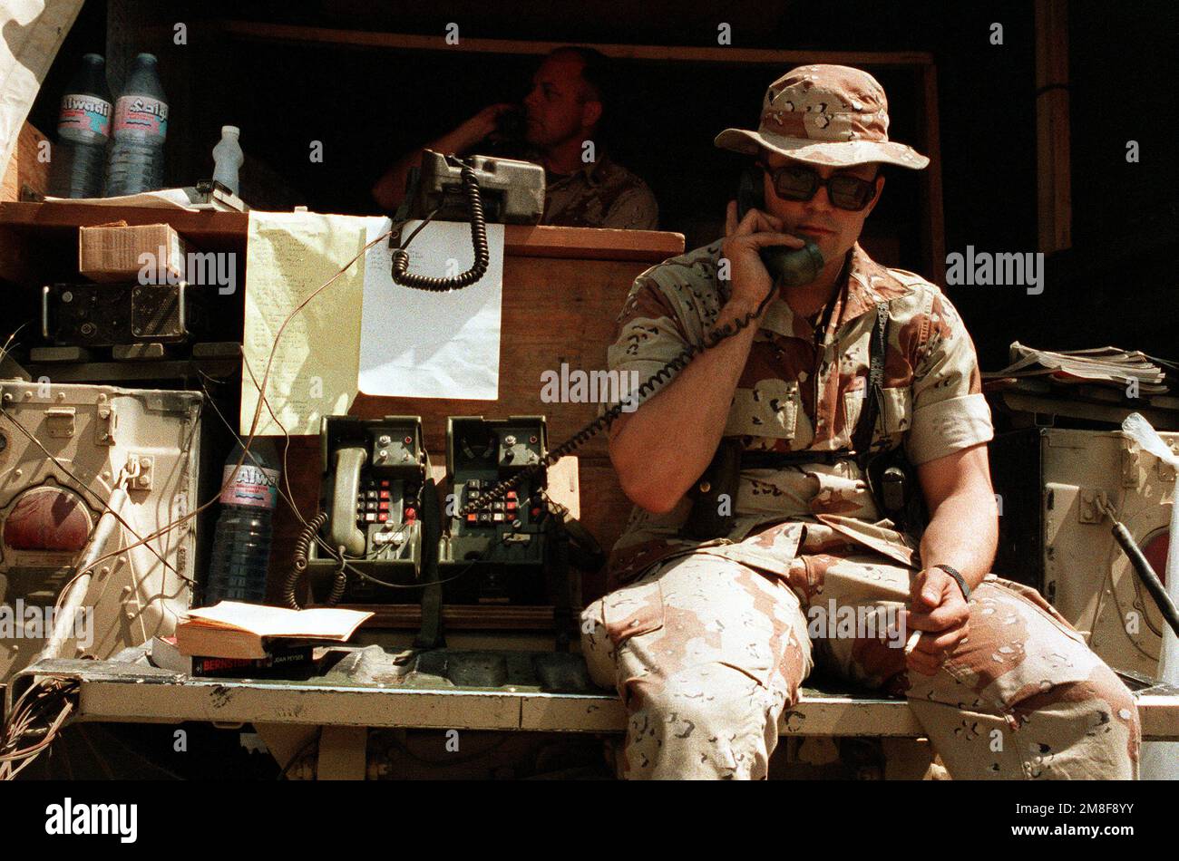 A Marine of Headquarters Battalion, 2nd Marine Division, communicates ...