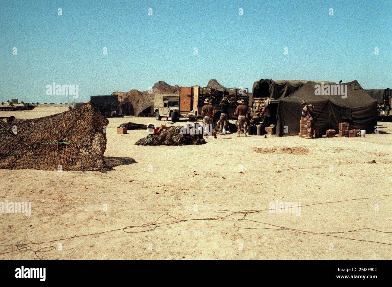 Marines of Headquarters Battalion, 2nd Marine Division, prepare to tear ...