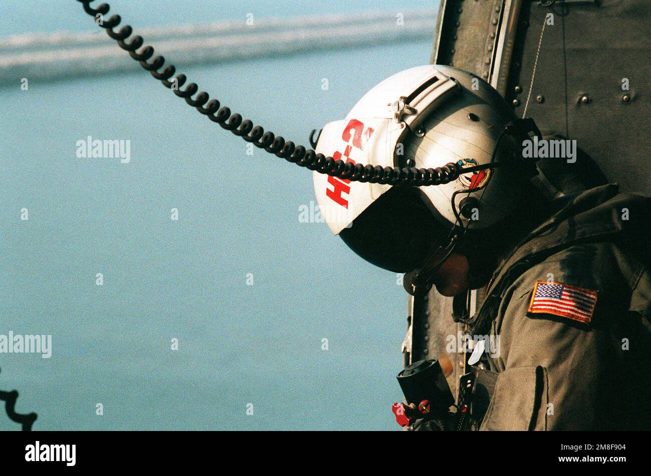 A member of Helicopter Combat Support Squadron 2 (HC-2) looks out the ...