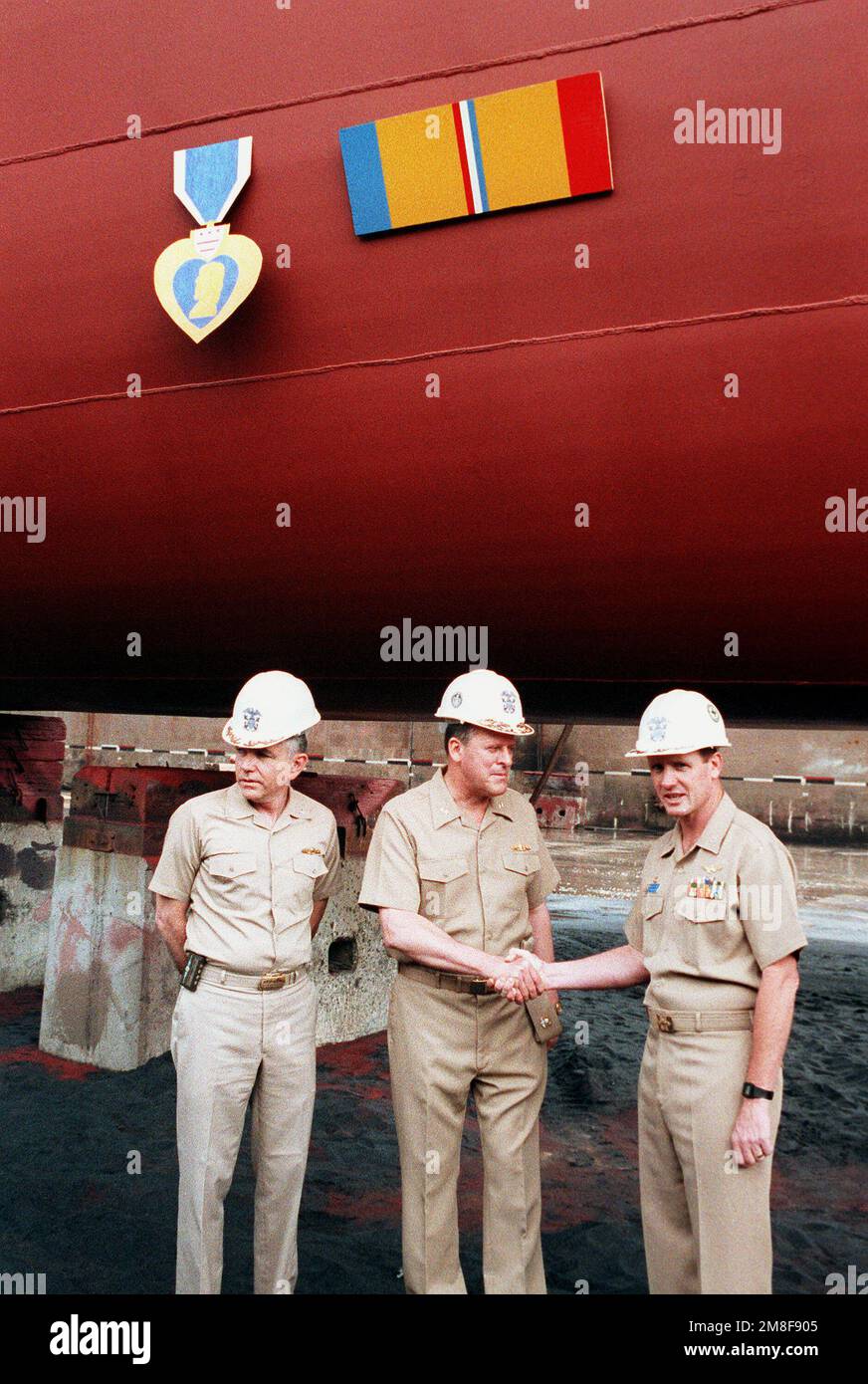 Rear Adm. Raynor A.K. Taylor, commander, Middle East Forces, shakes ...