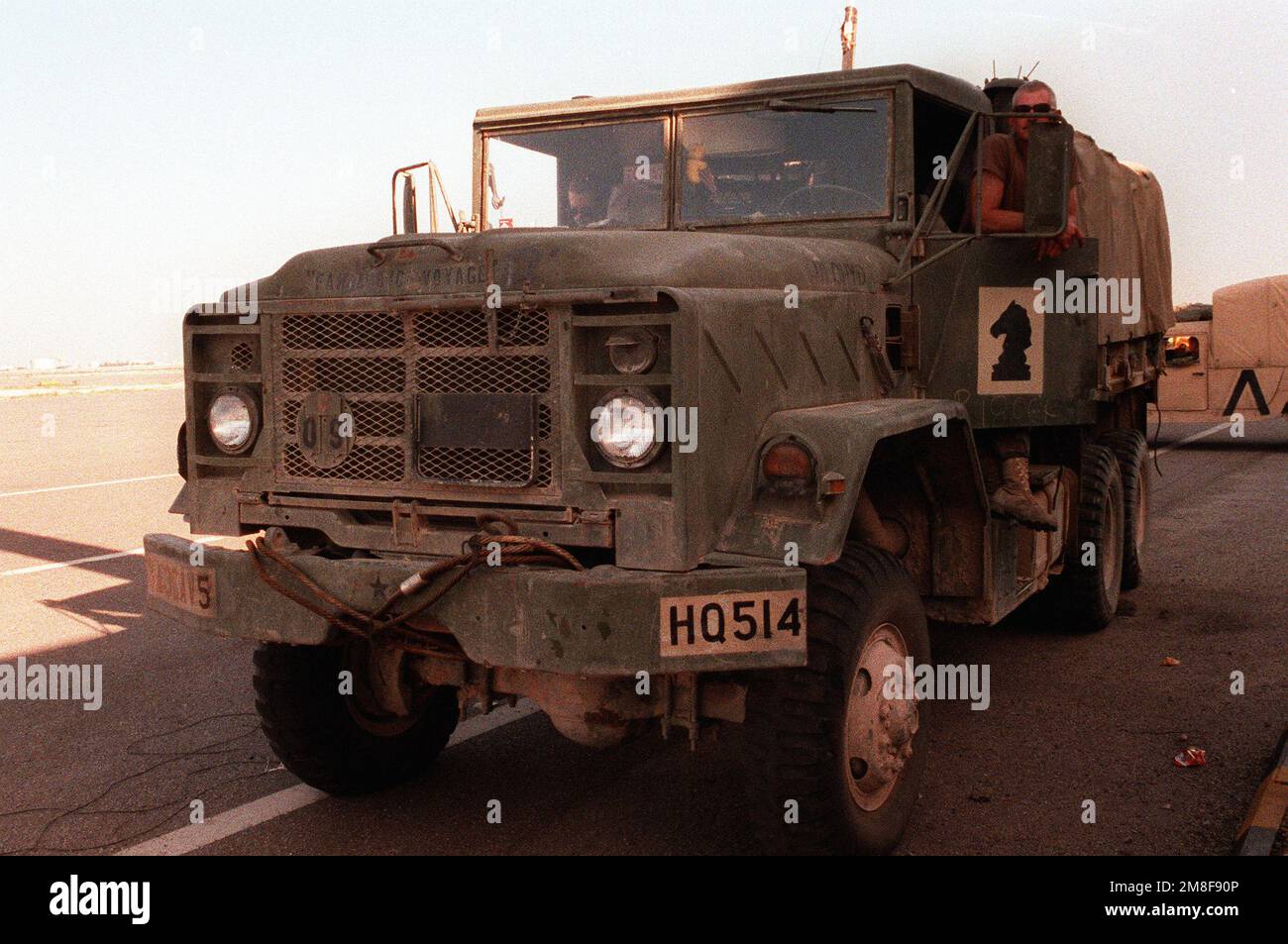 A soldier observes activity from the door of his M-939 5-ton cargo ...