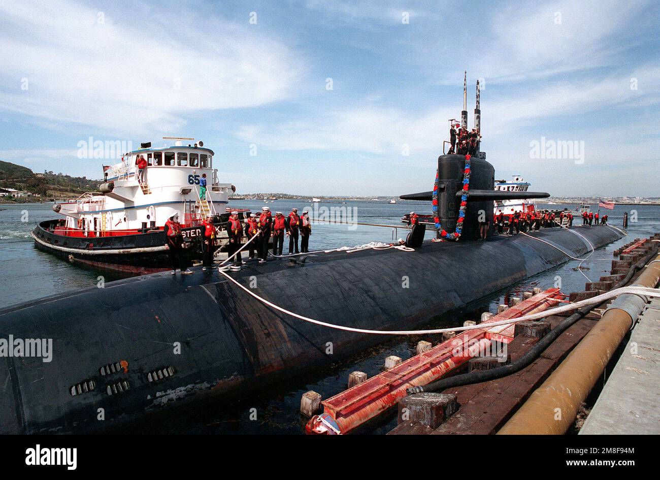 Line handlers aboard the nuclear-powered attack submarine USS CHICAGO ...