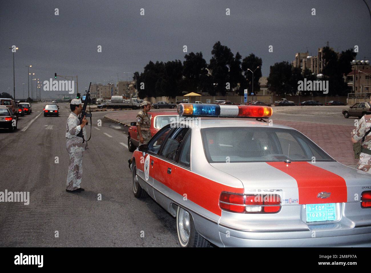 A member of the Kuwaiti police force, armed with an M-16A2 rifle ...