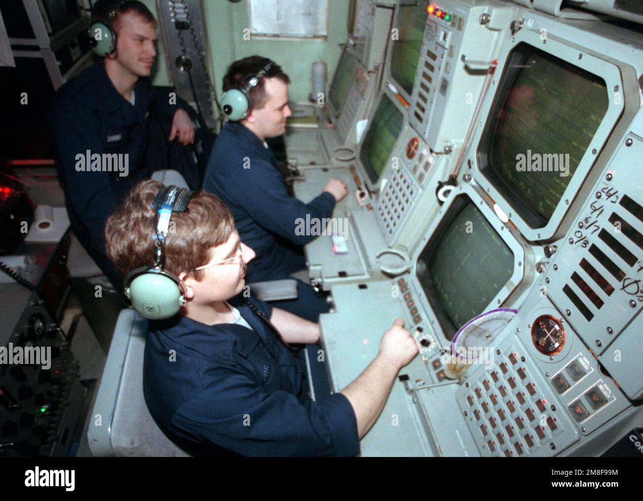 Systems operators work aboard the nuclear-powered attack submarine USS ...