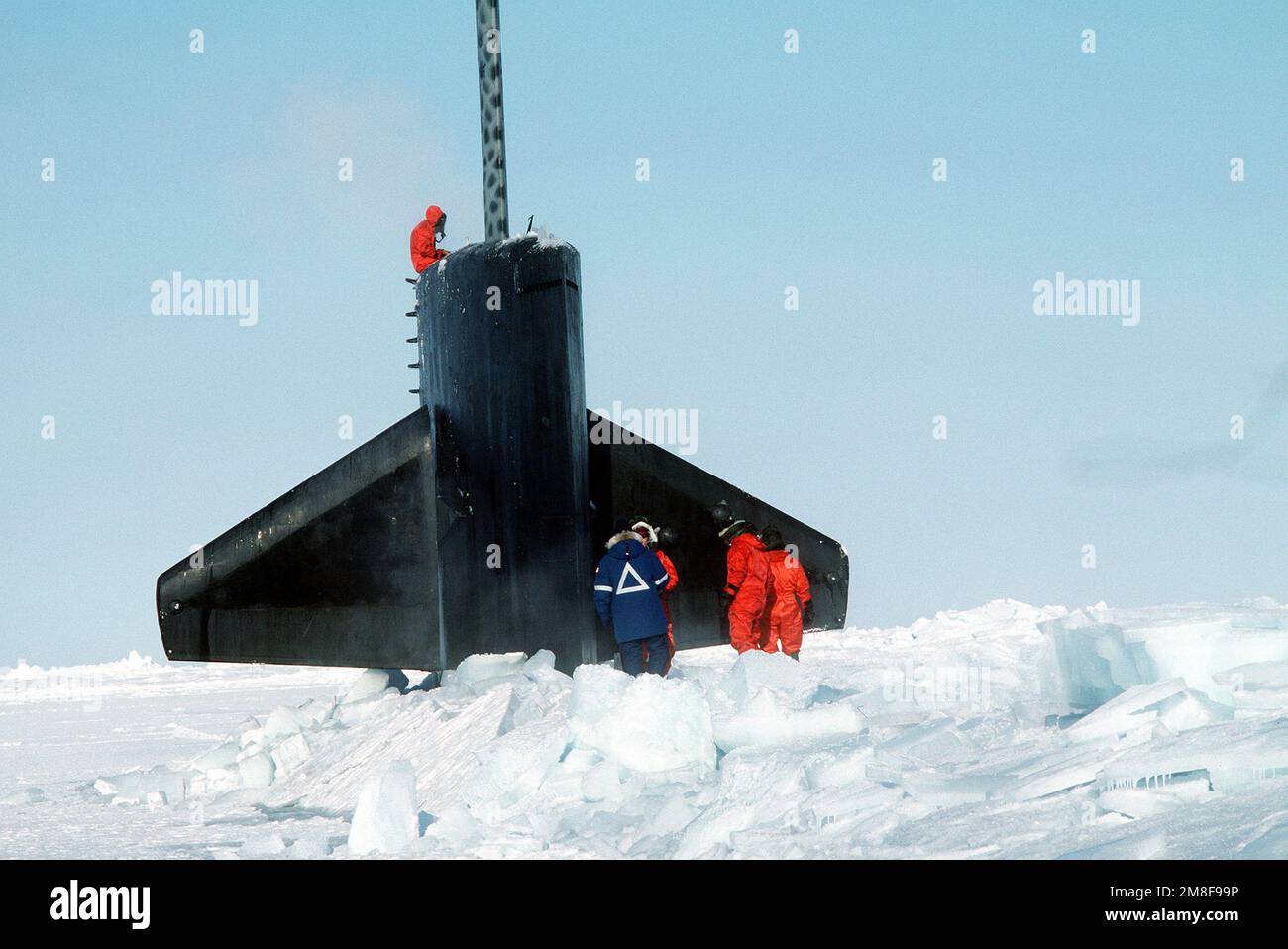 U.S. military personnel inspect the sail of the nuclear-powered attack submarine USS PARGO (SSN ...