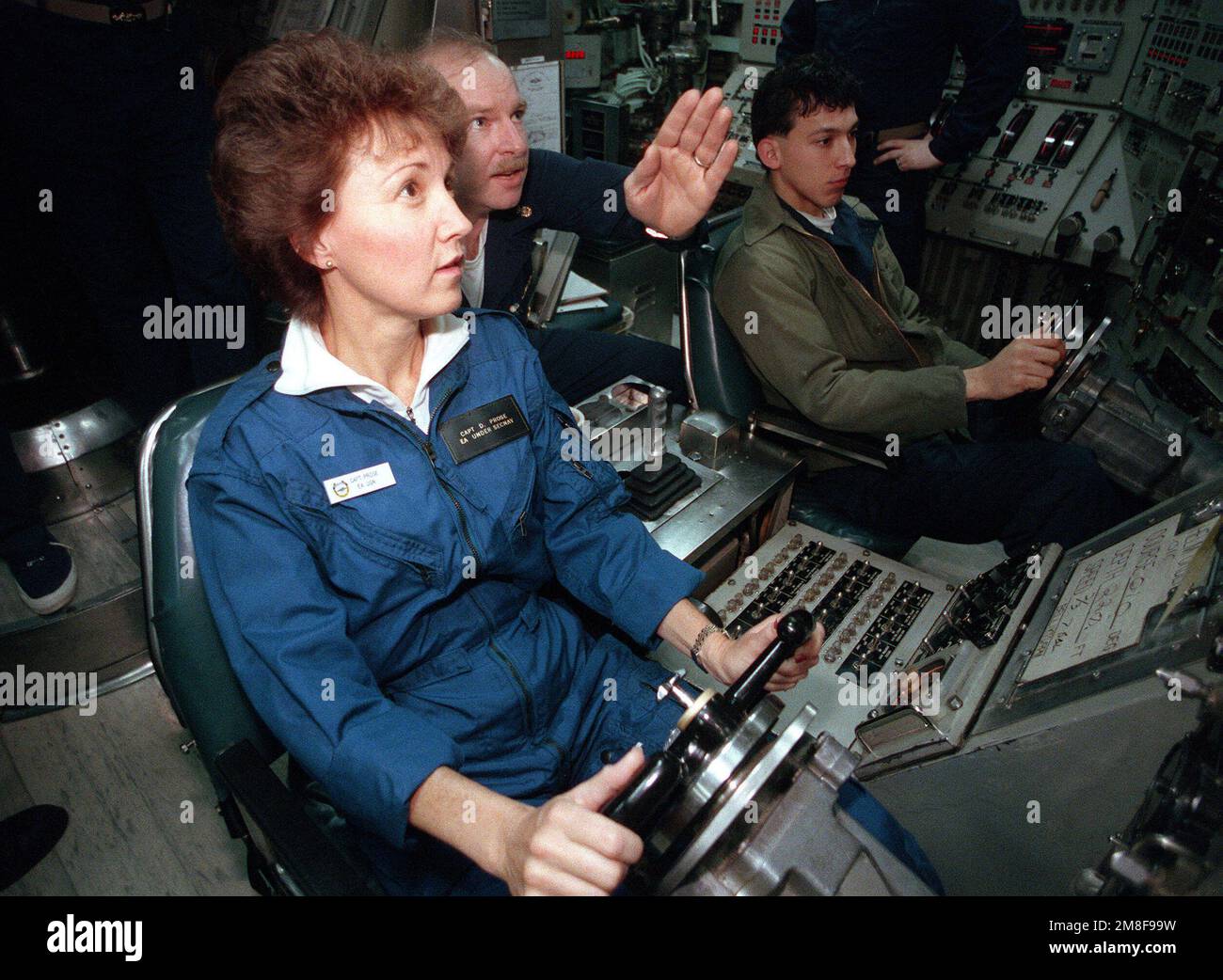 A chief petty officer gives some instructions to CAPT Dorothy A. Prose ...