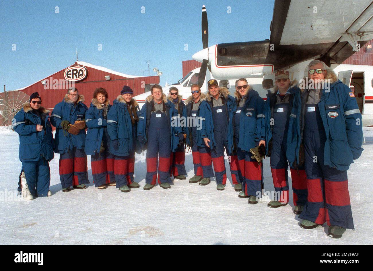 Standing beside the aircraft that will carry them north of the Arctic ...
