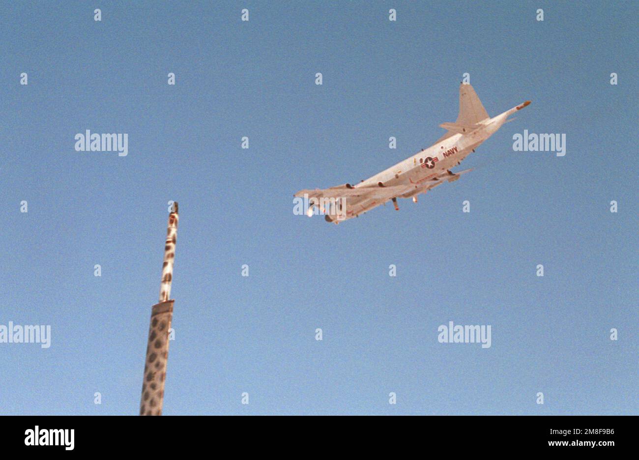 A P-3C Orion aircraft flies over the nuclear-powered attack submarine ...
