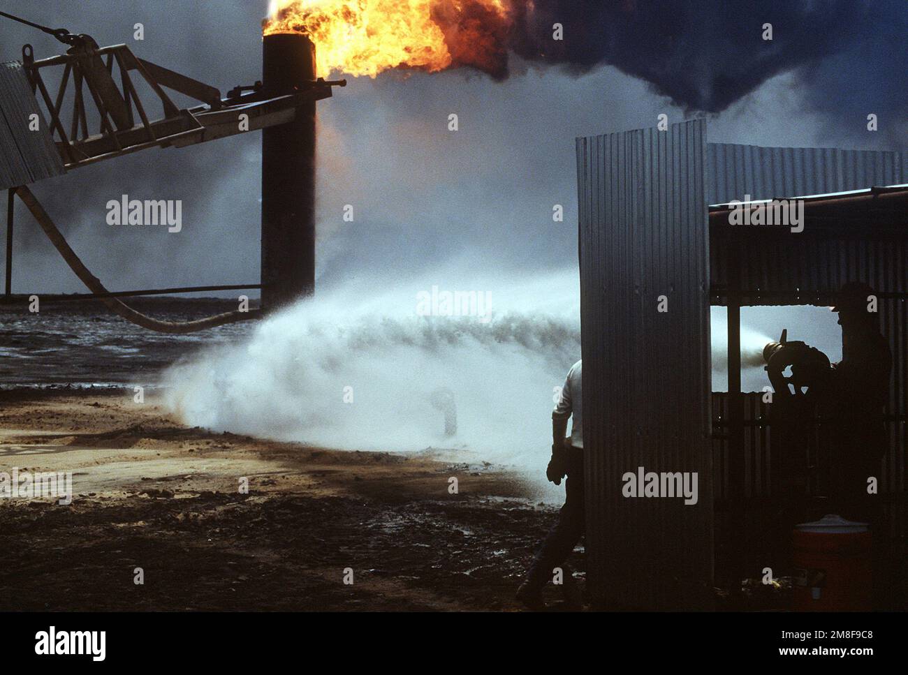 Firefighters from the Boots and Coots Oil Well Firefighting Company ...