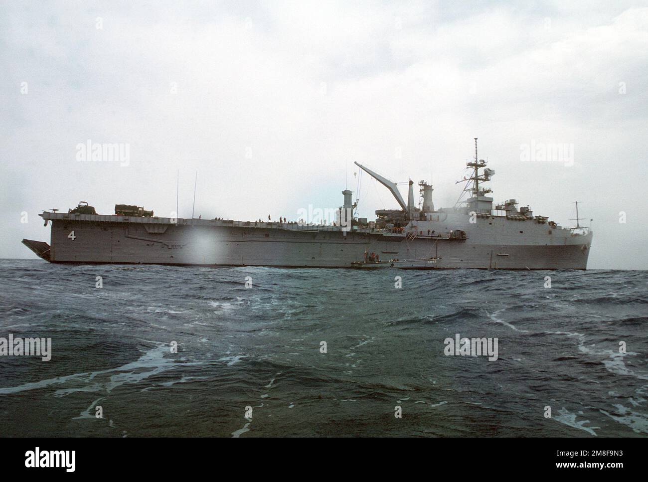 An LCM-8 mechanized landing craft is moored alongside the amphibious ...