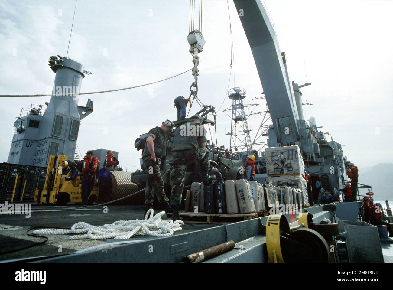 Marines organize supplies and equipment aboard the amphibious transport ...