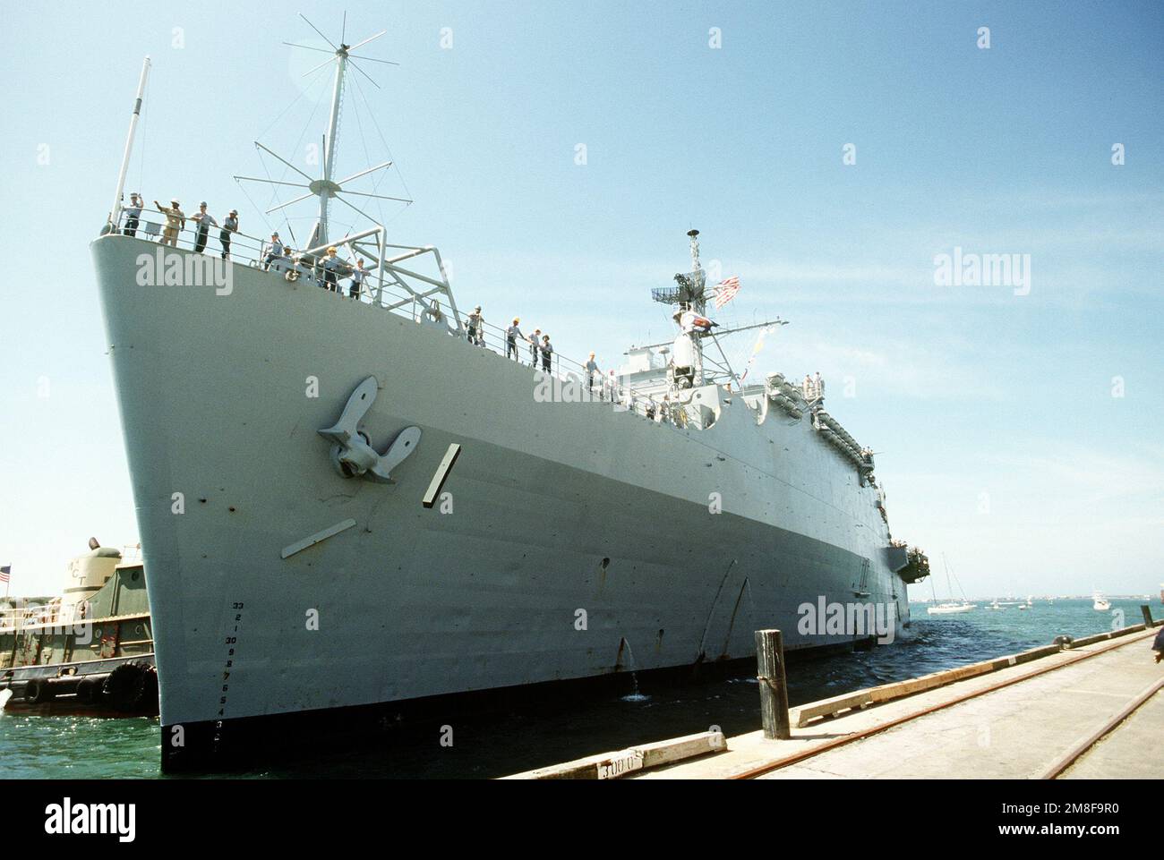 Line handlers stand by aboard the amphibious transport dock USS RALEIGH ...