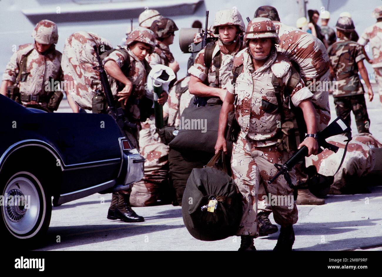 Marines from the 4th Marine Expeditionary Brigade (4th MEB) carry their ...