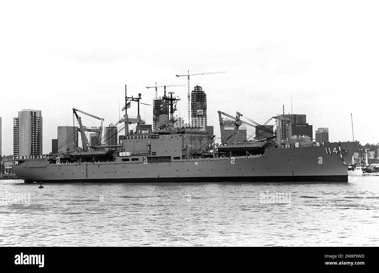 A garland decorates the bow of the amphibious cargo ship USS DURHAM ...