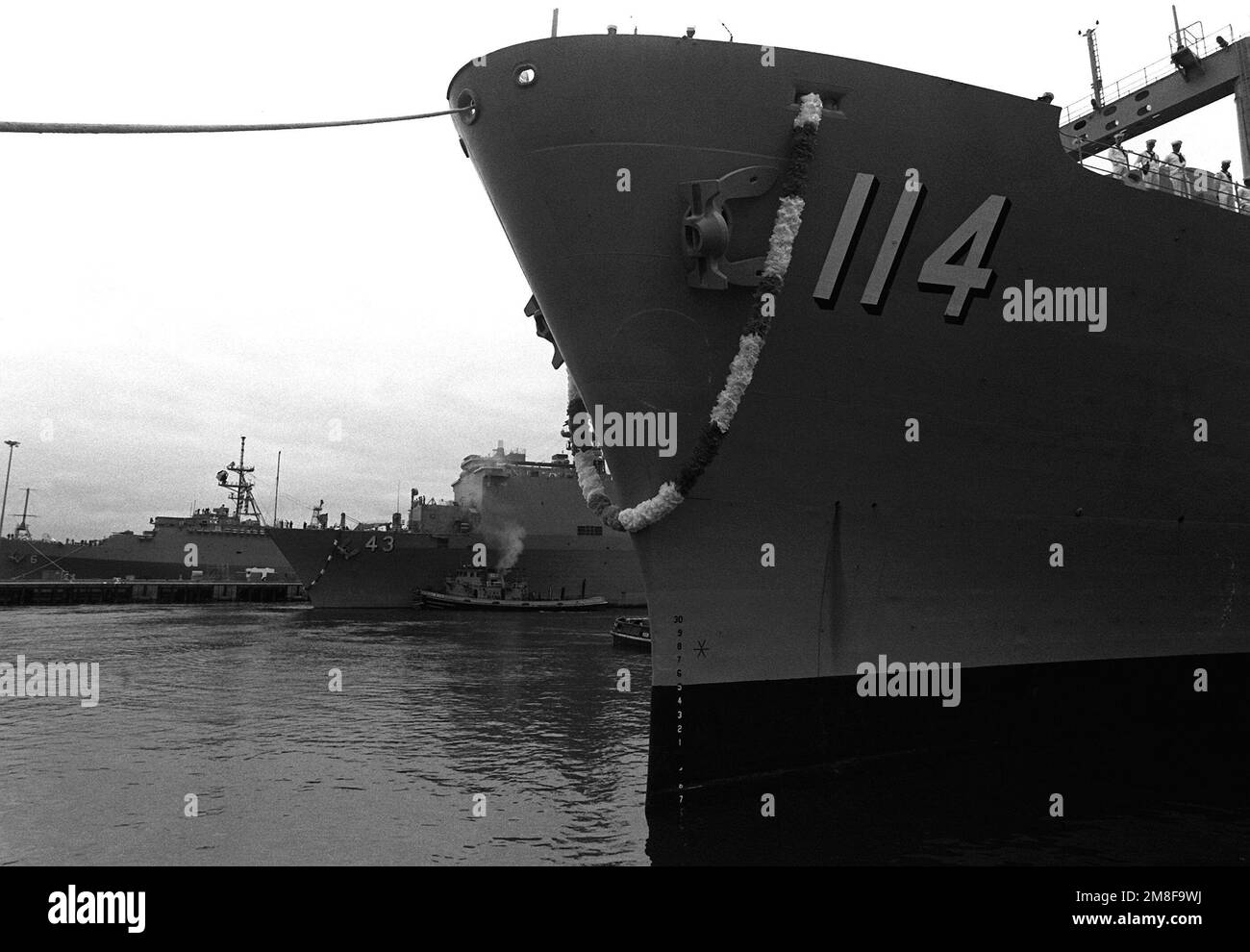 A garland decorates the bow of the amphibious cargo ship USS DURHAM ...