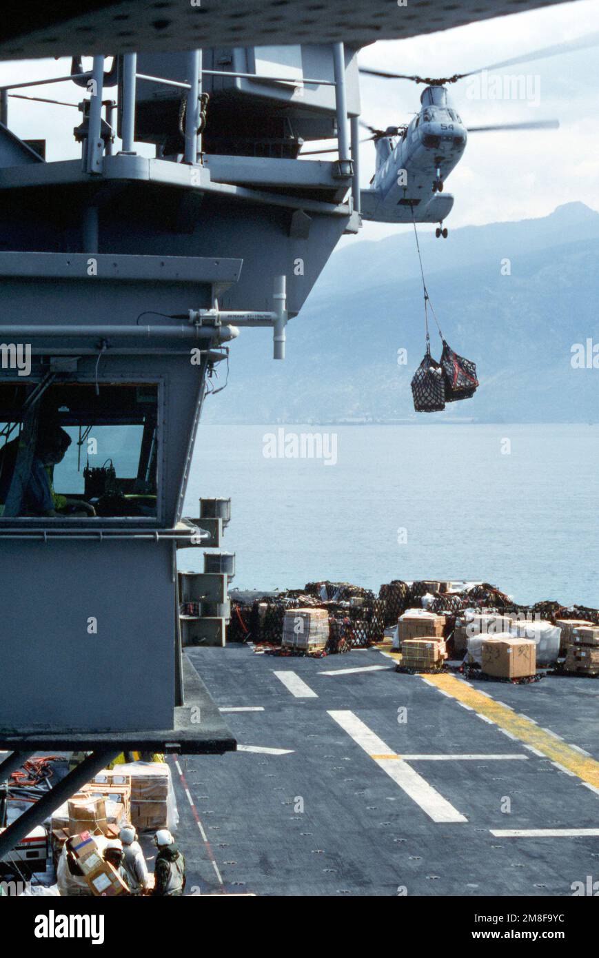 A UH-46 Sea Knight helicopter delivers supplies to the amphibious ...