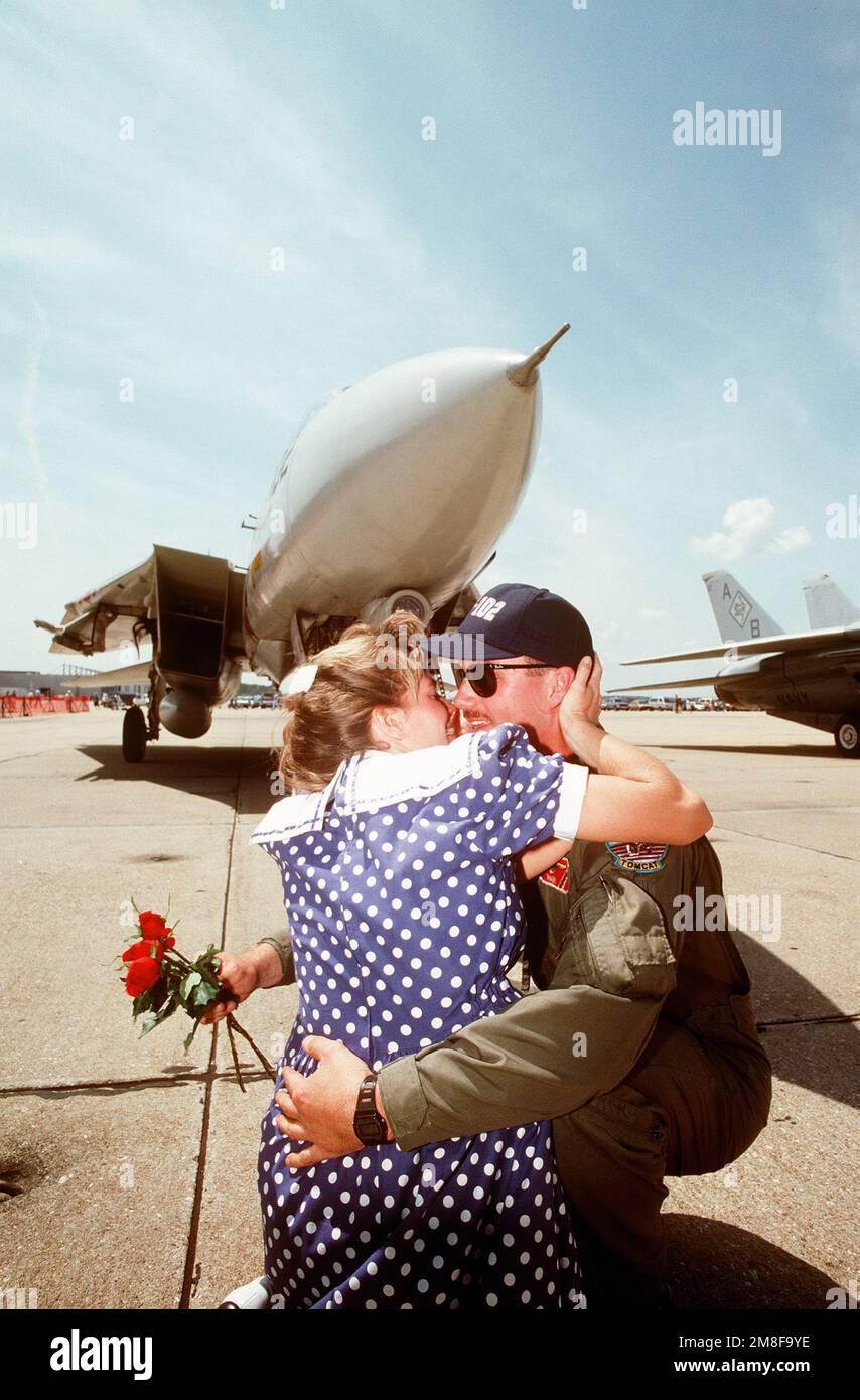 A pilot from Fighter Squadron 102 (VF-102) is reunited with a loved one ...
