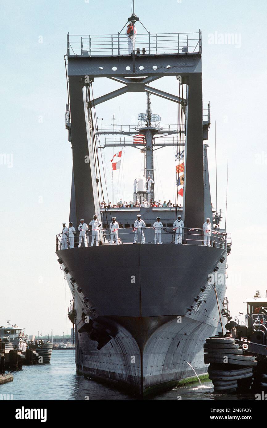 Sailors man the rails on the bow of the tank landing ship USS MANITOWOC ...