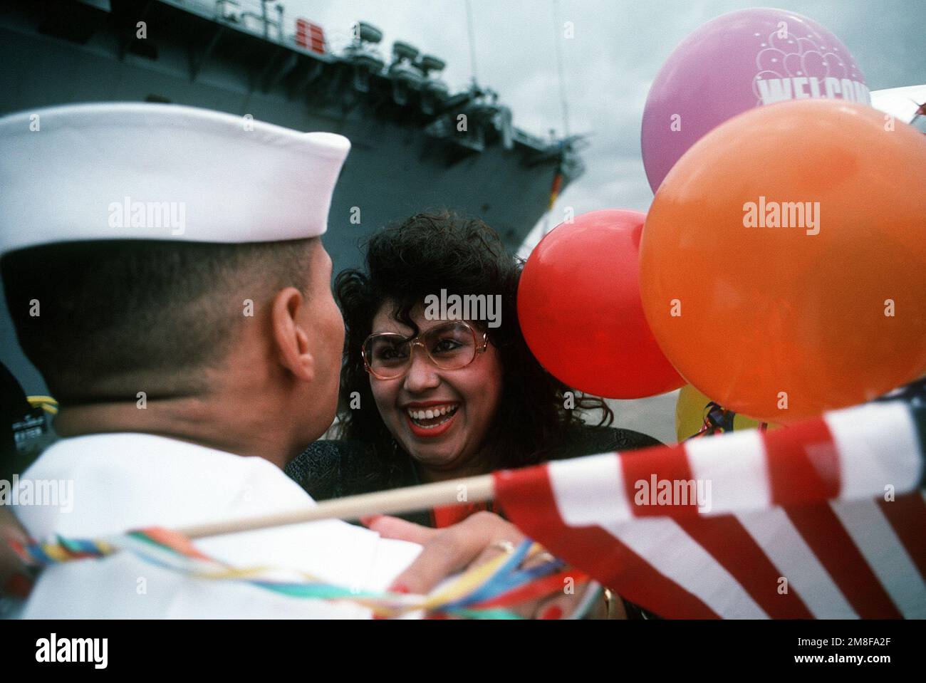 A sailor assigned to the amphibious assault ship USS OKINAWA (LPH-3) is reunited with his wife ...
