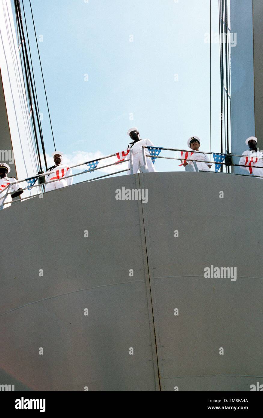 Crew members man the rails on the bow of a tank landing ship as it ...