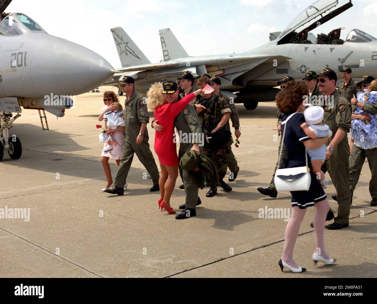 Pilots from Fighter Squadron 33 (VF-33) are welcomed by their loved ...