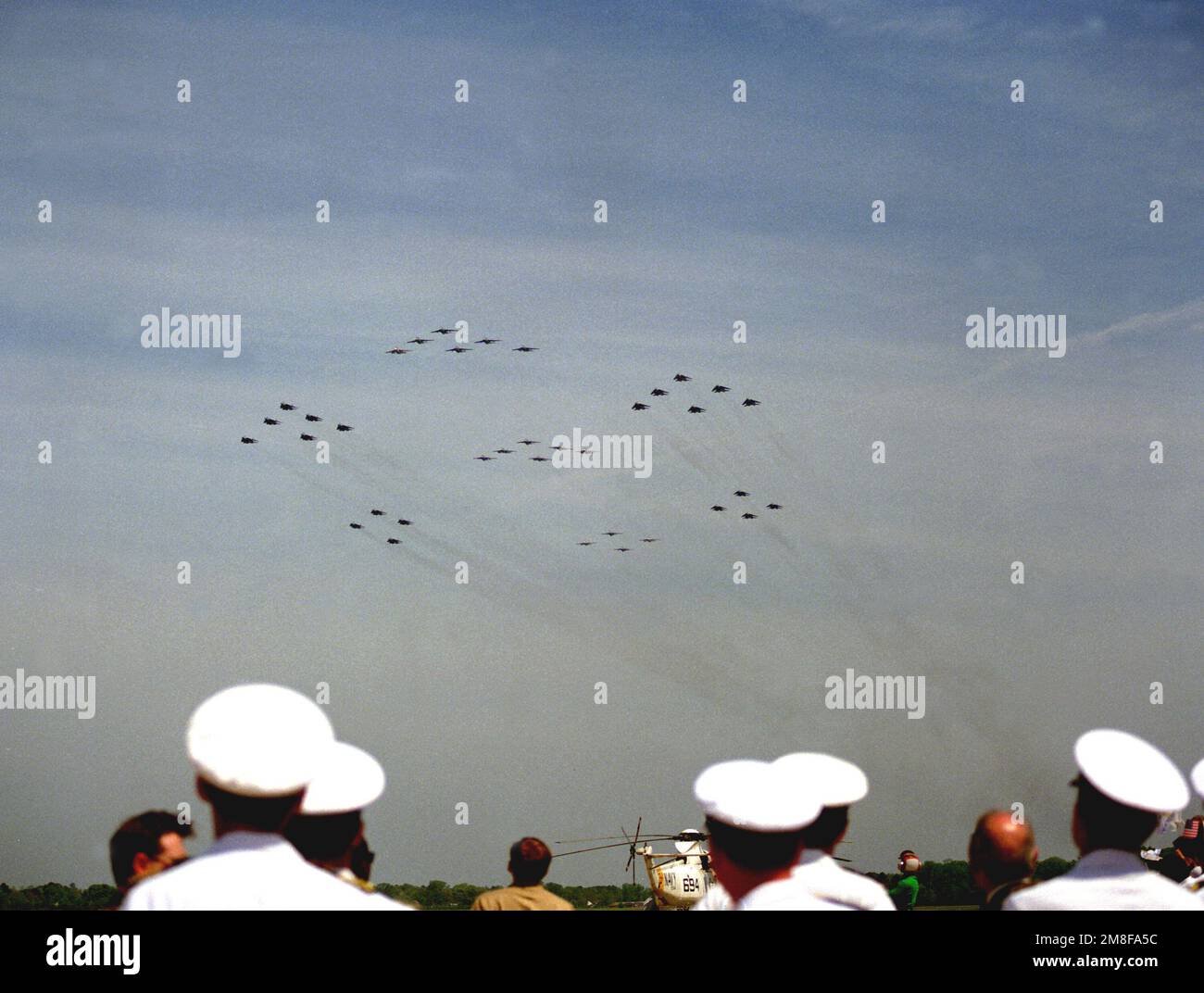 Navy officers watch a flyover comprised of Carrier Air Wing 1 (CVW-1 ...