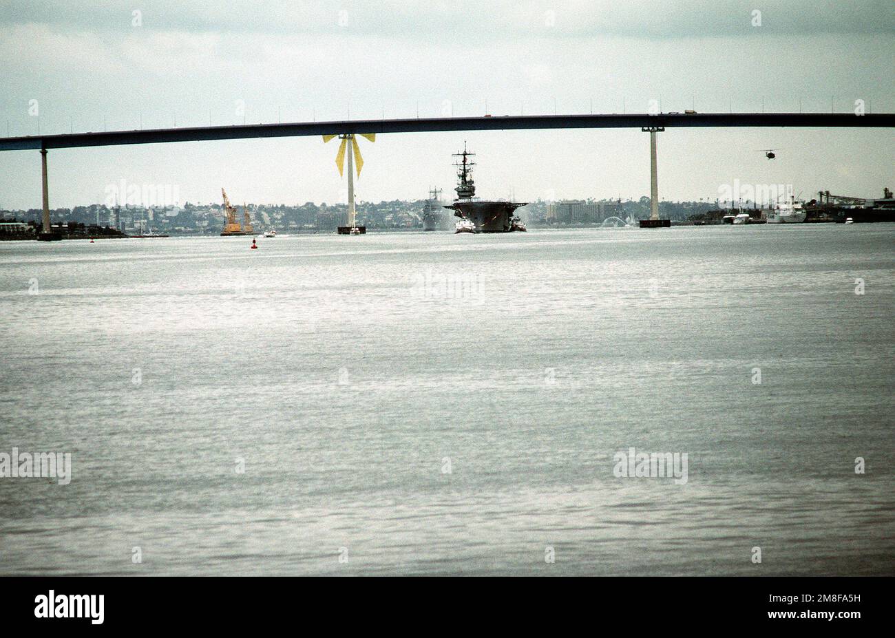 The amphibious assault ship USS OKINAWA (LPH-3) prepares to pass under ...