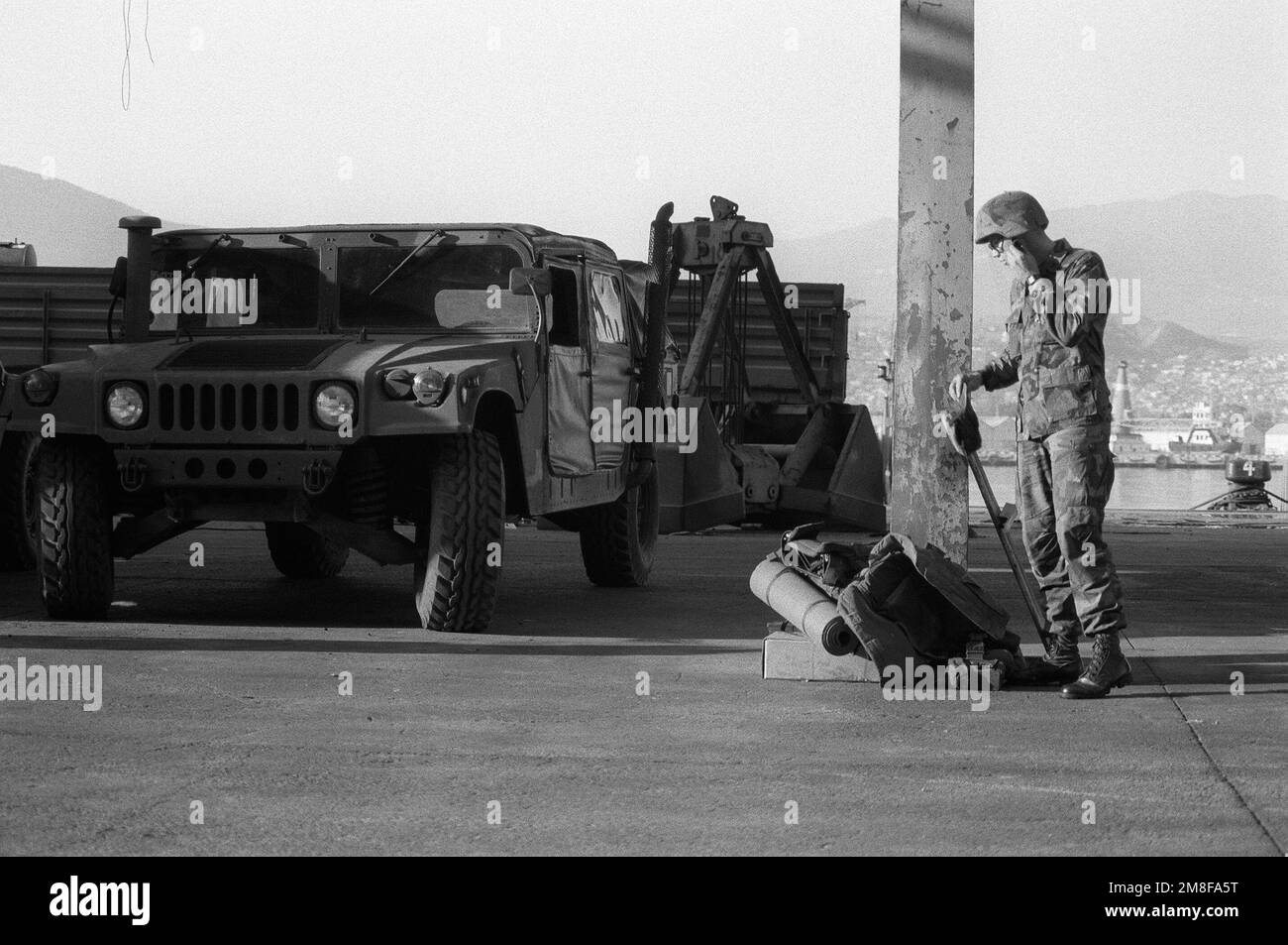 A Marine stands by an M998 High-Mobility Multipurpose Wheeled Vehicle ...