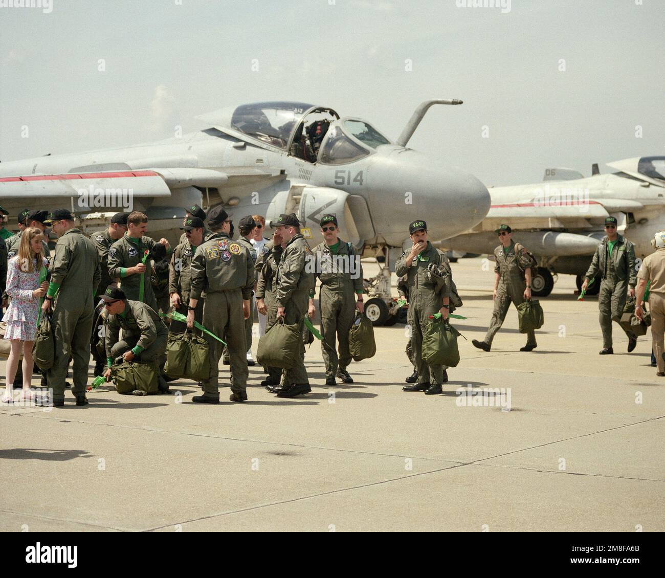 Pilots from Carrier Air Wing 1 (CVW-1) walk past an Attack Squadron 85 ...