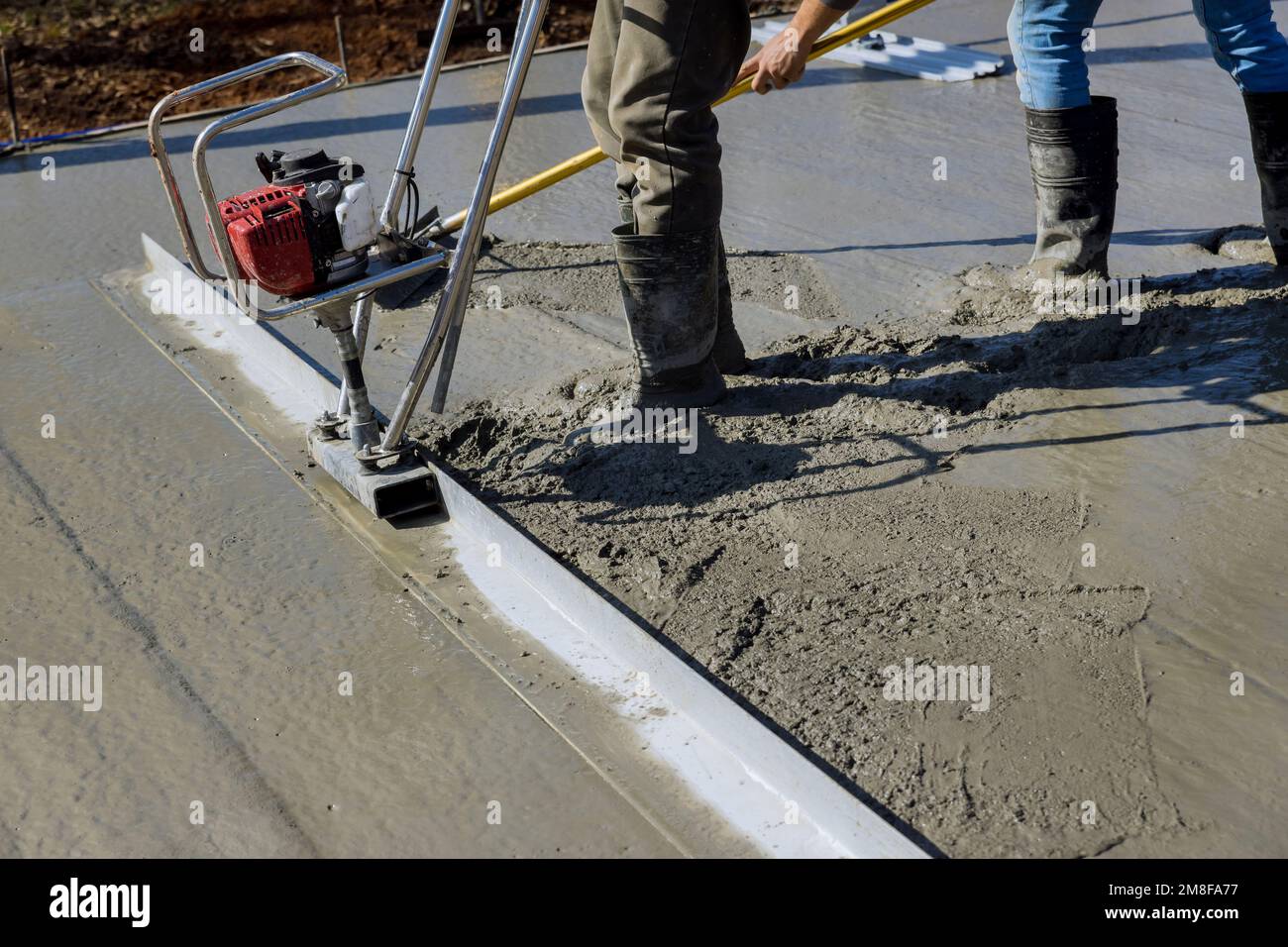 When constructing new driveway machine is used to align fresh concrete ...