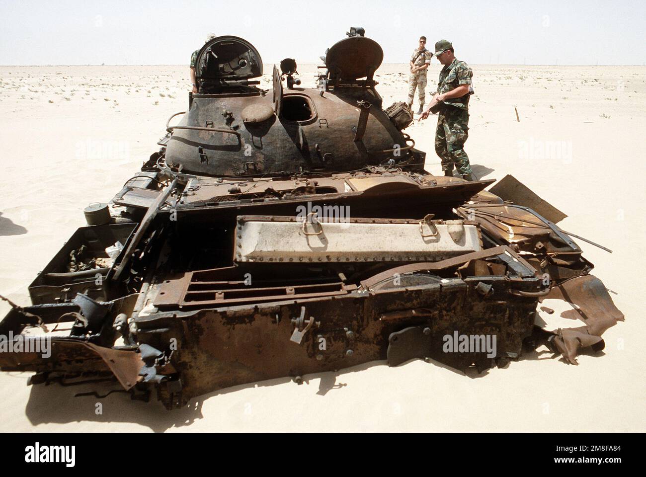 U.S. soldiers inspect an Iraqi T-62 main battle tank destroyed near Ali ...