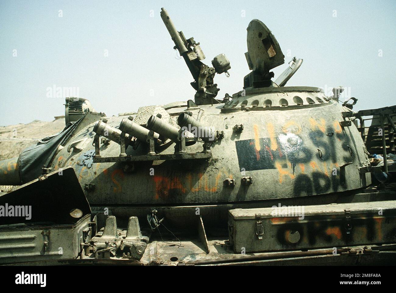A close-up view of the graffiti-covered turret of an Iraqi T-55 main ...