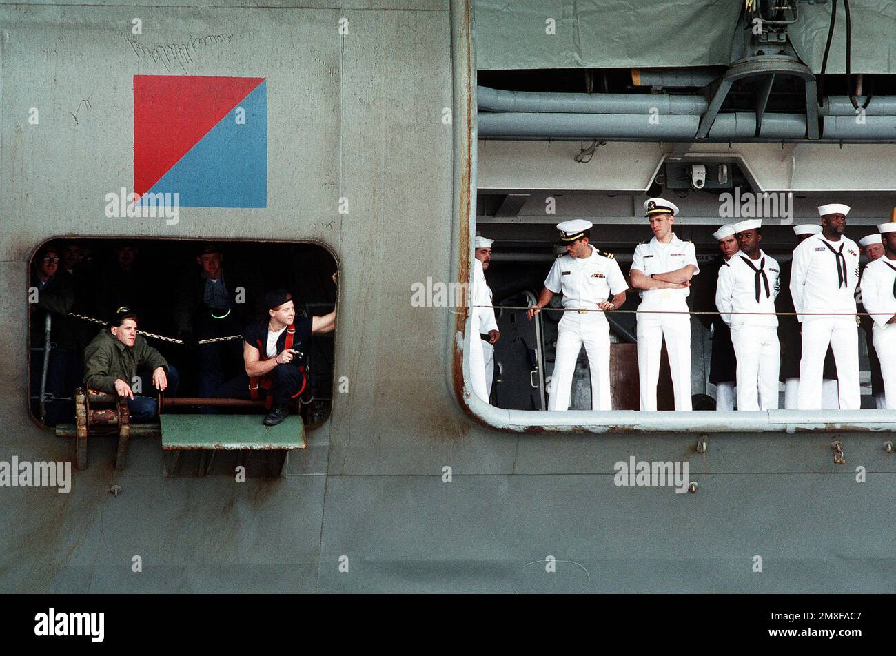 Crew members look out from the lower deck and refueling transfer ...