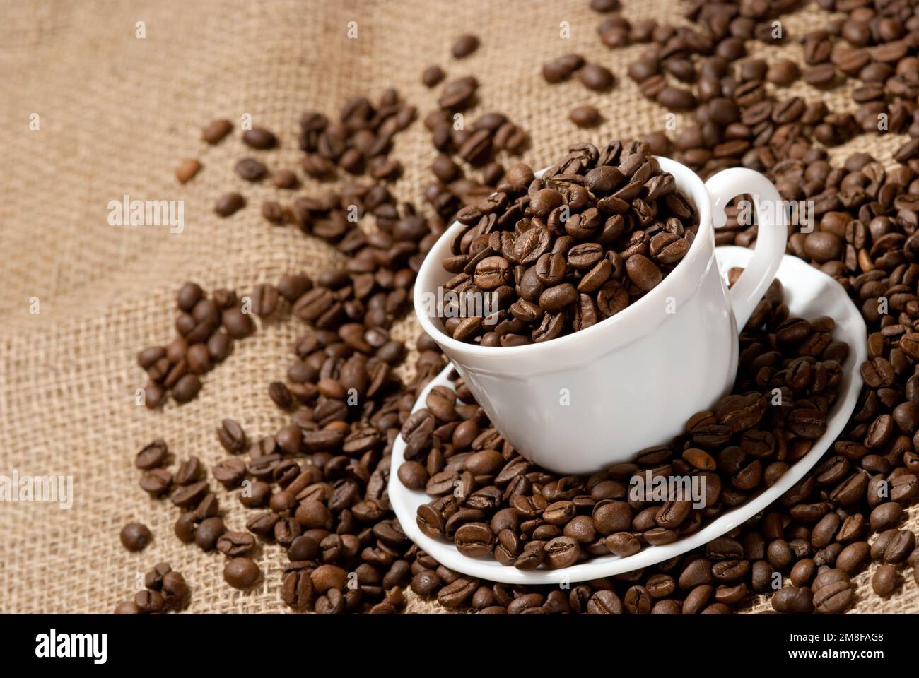 Roasted coffee beans on a sacking background Stock Photo - Alamy