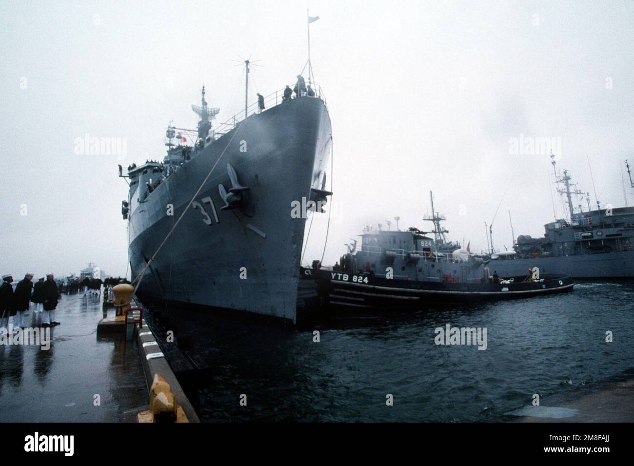 The large harbor tug SANTAQUIN (YTB-824) moves the dock landing ship ...