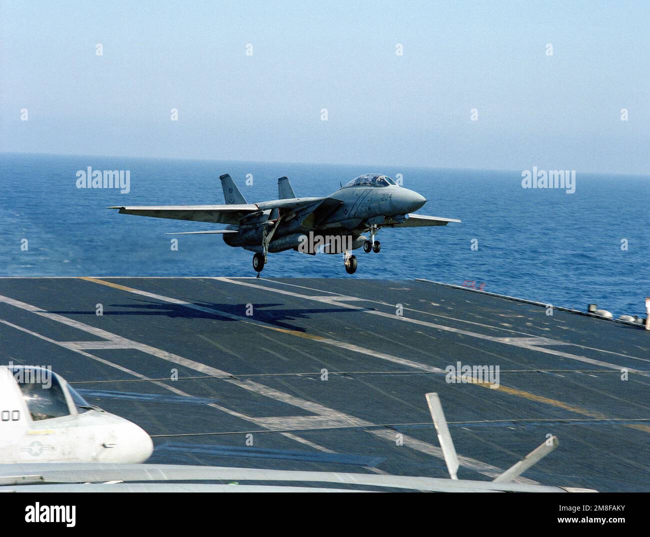 A Fighter Squadron 84 (VF-84) F-14A Tomcat aircraft comes in for an ...