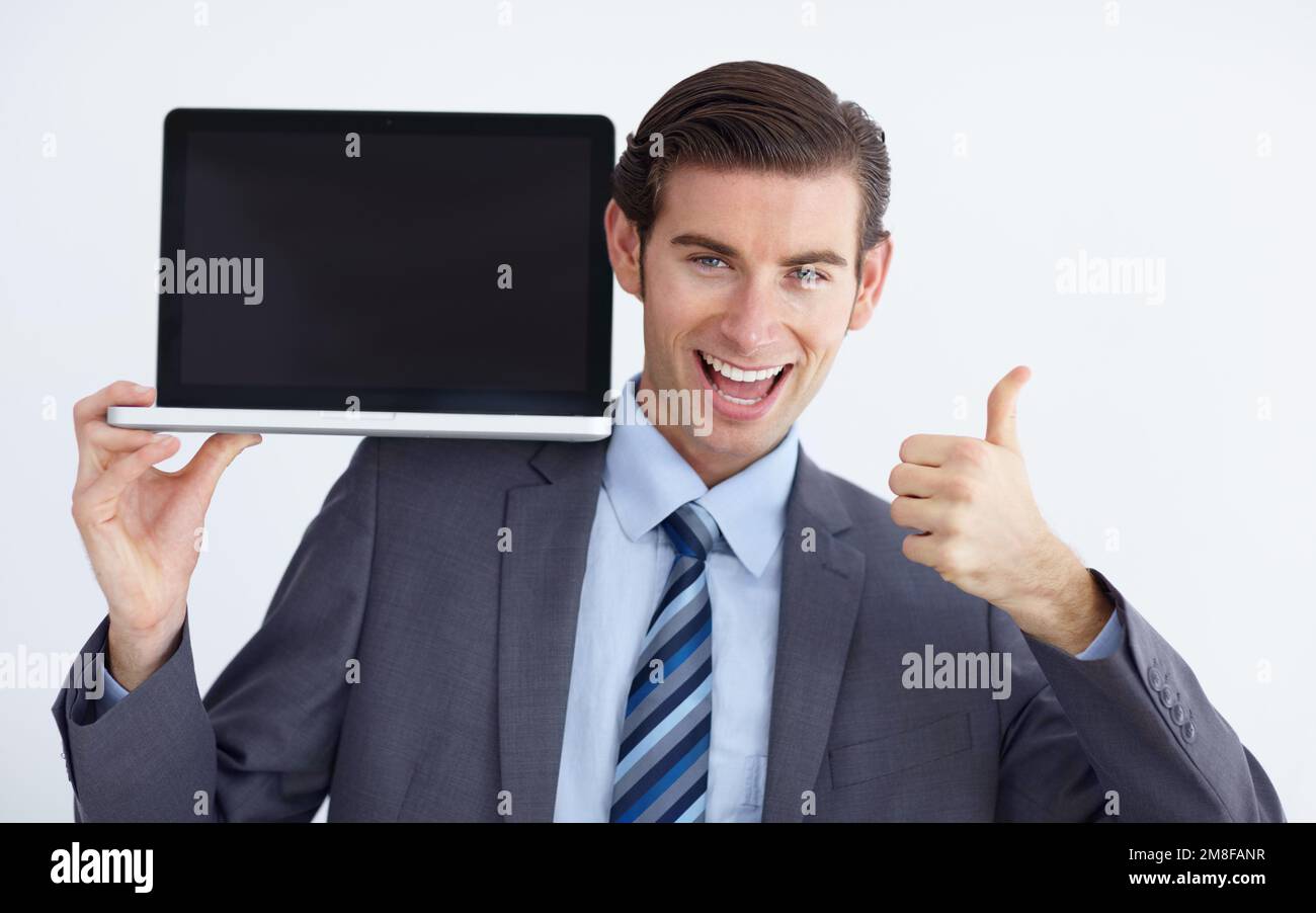 I endorse this. A young businessman endorsing a laptop with a thumbs up ...
