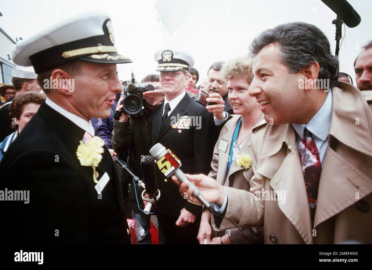 A member of the media interviews CAPT. Paul Barry, commanding officer ...