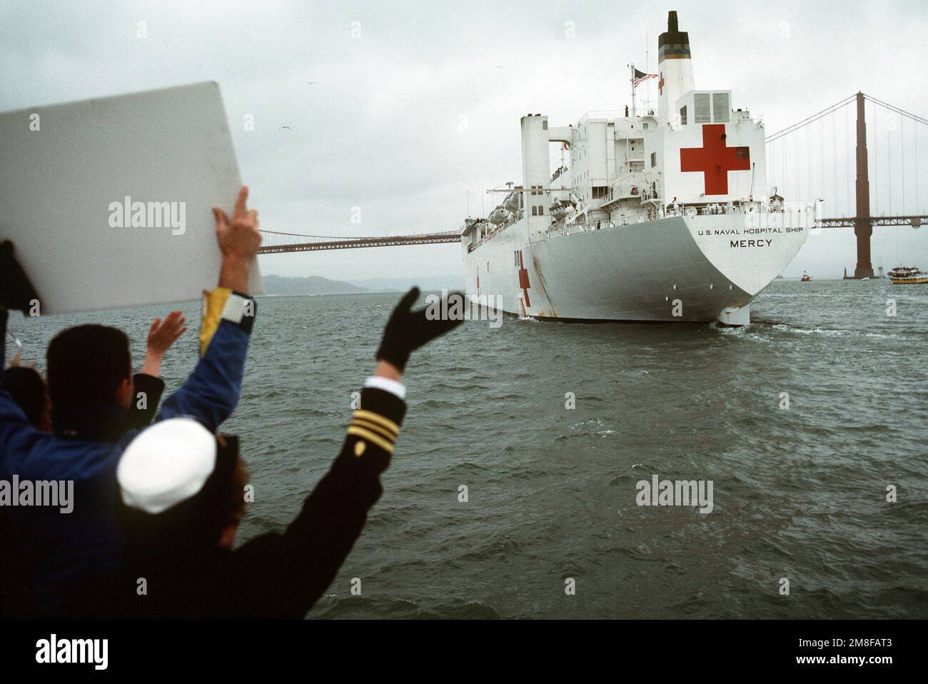 A boat carrying U.S. Navy personnel approaches the hospital ship USNS ...