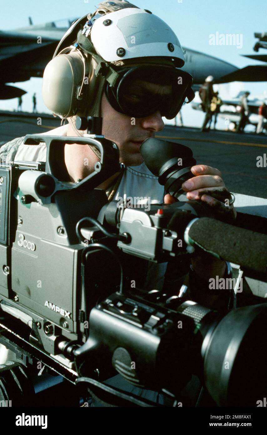A Navy cameraman videotapes flight operations aboard the nuclear ...
