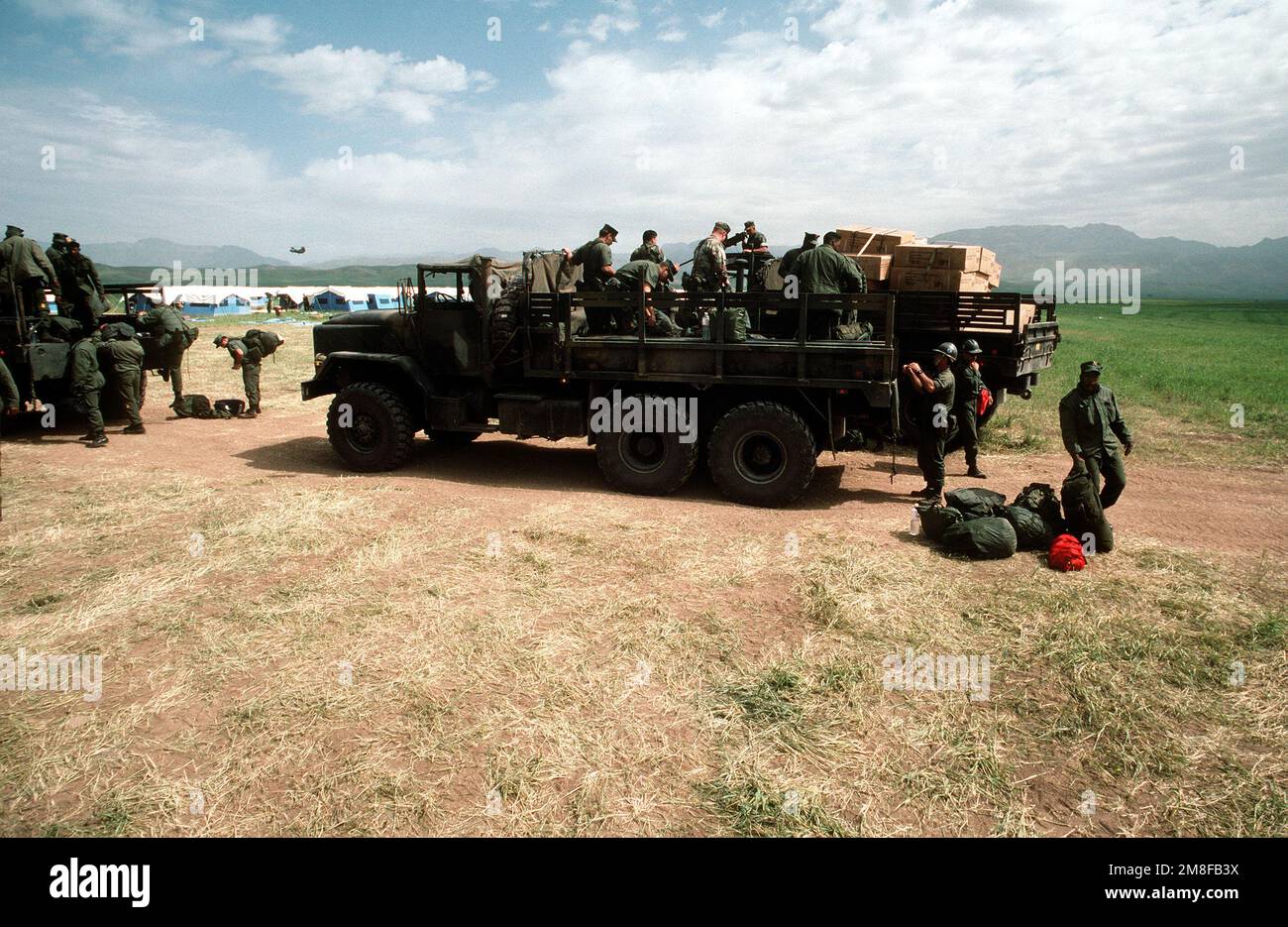 U.S. military personnel disembark from M-934 5-ton cargo trucks as they ...
