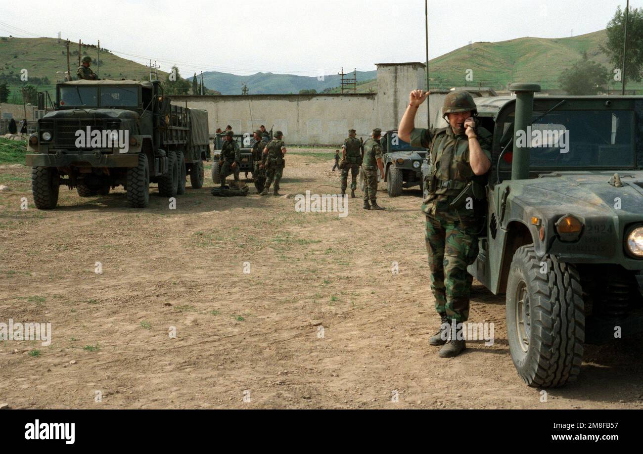 A member of Marine Service Support Group 24 (MSSG-24) relays ...