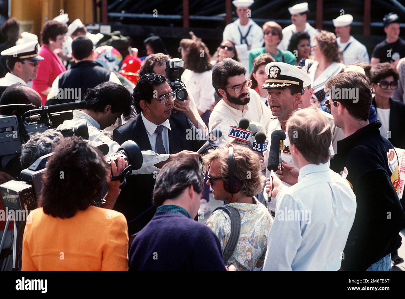 Members of the news media interview the commanding officer of the ...