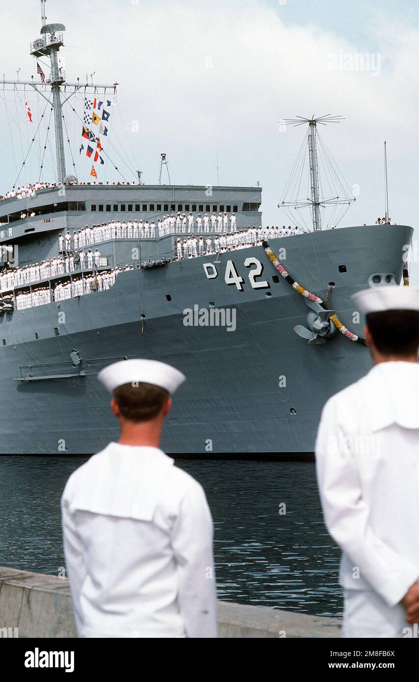 Line handlers stand by on the pier as the destroyer tender USS ACADIA ...