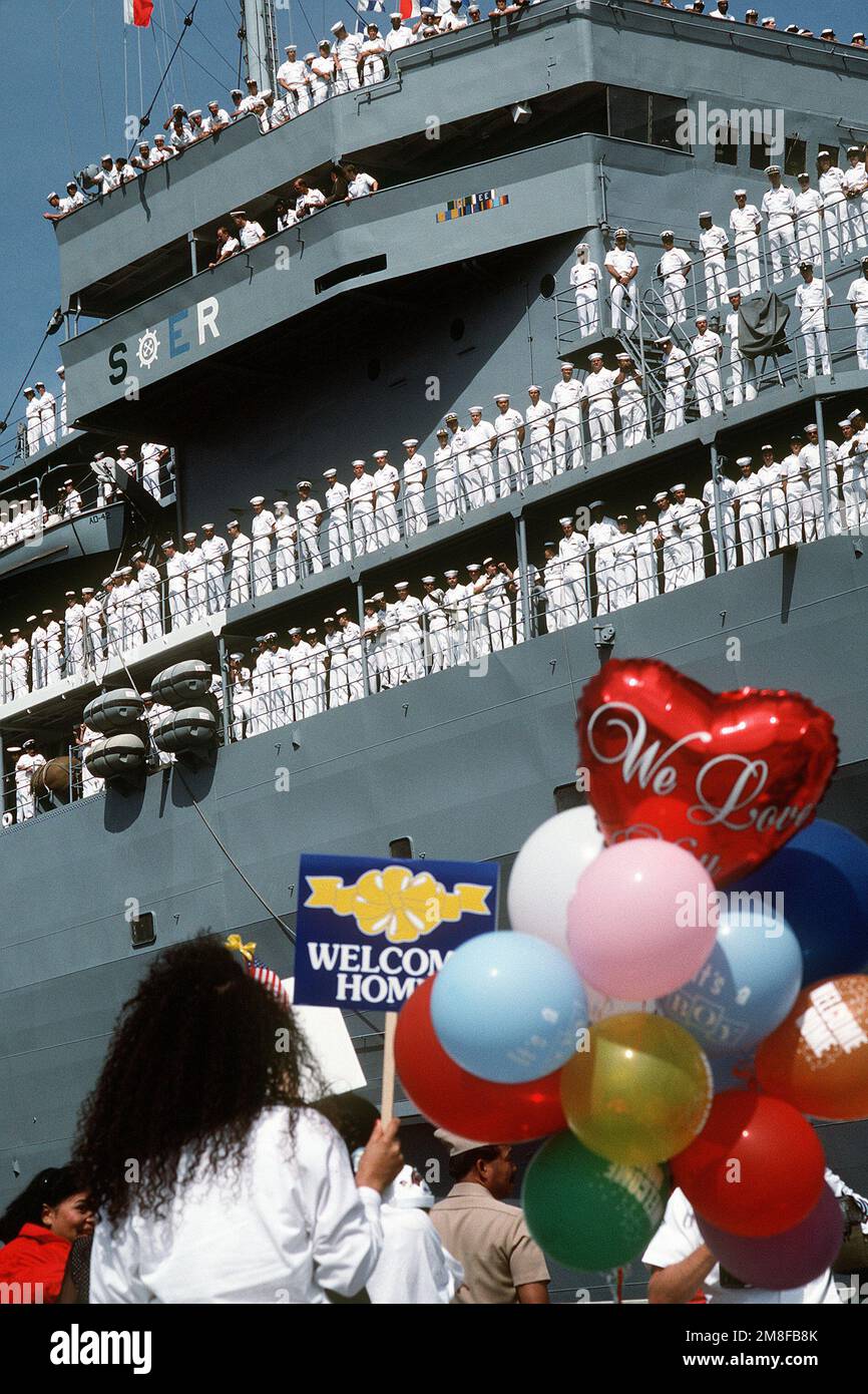 The crew of the destroyer tender USS ACADIA (AD-42) mans the rails as ...