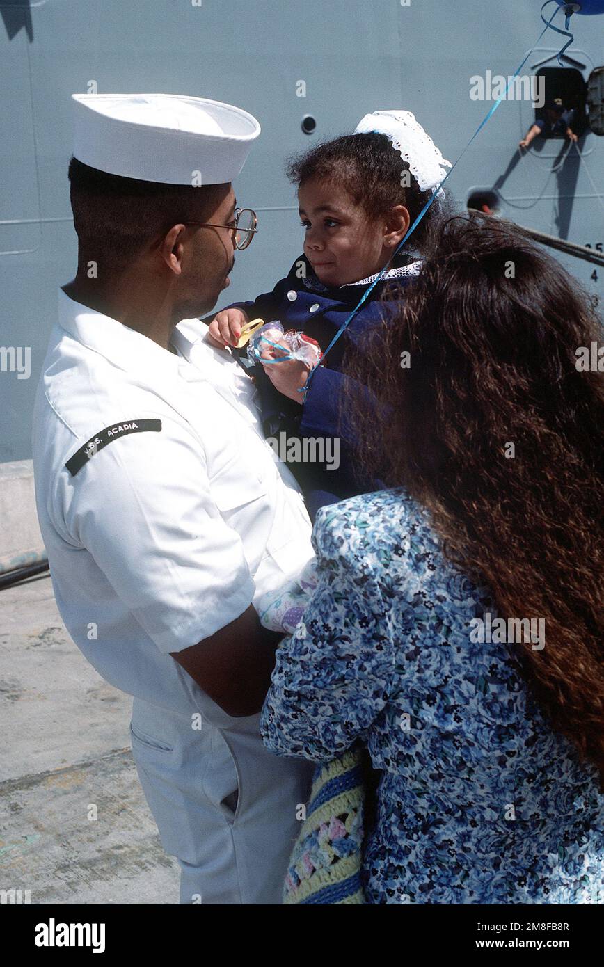 A sailor from the destroyer tender USS ACADIA (AD-42) is reunited with ...
