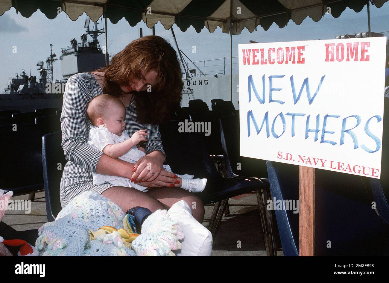 The wife of a sailor assigned to the destroyer tender USS ACADIA (AD-42 ...
