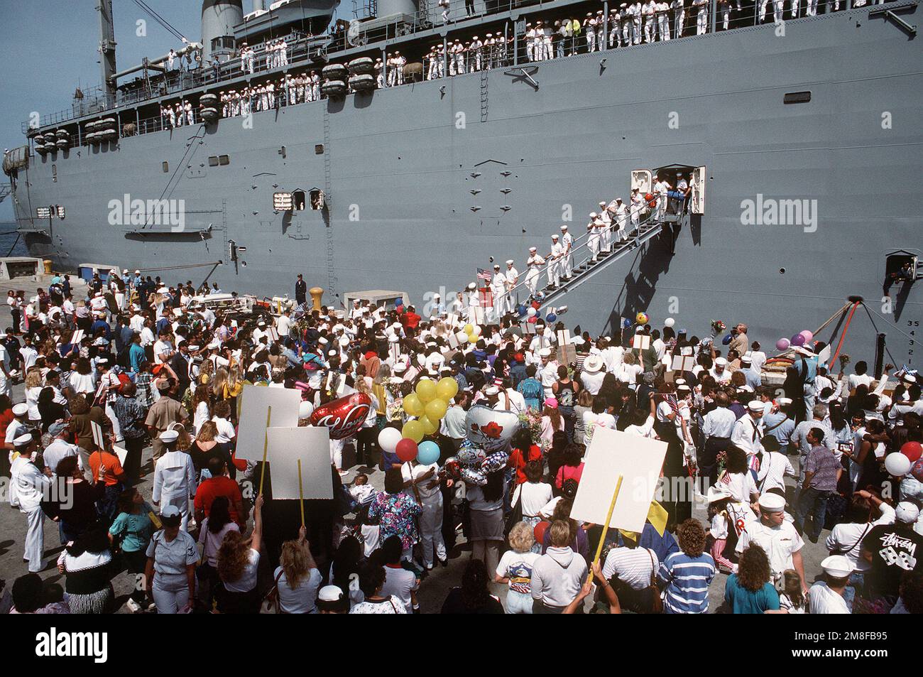 Family members and friends wait on the pier as members of the crew of ...