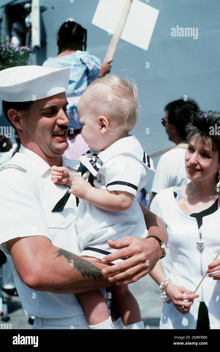 A sailor assigned to the destroyer tender USS ACADIA (AD-42) is ...